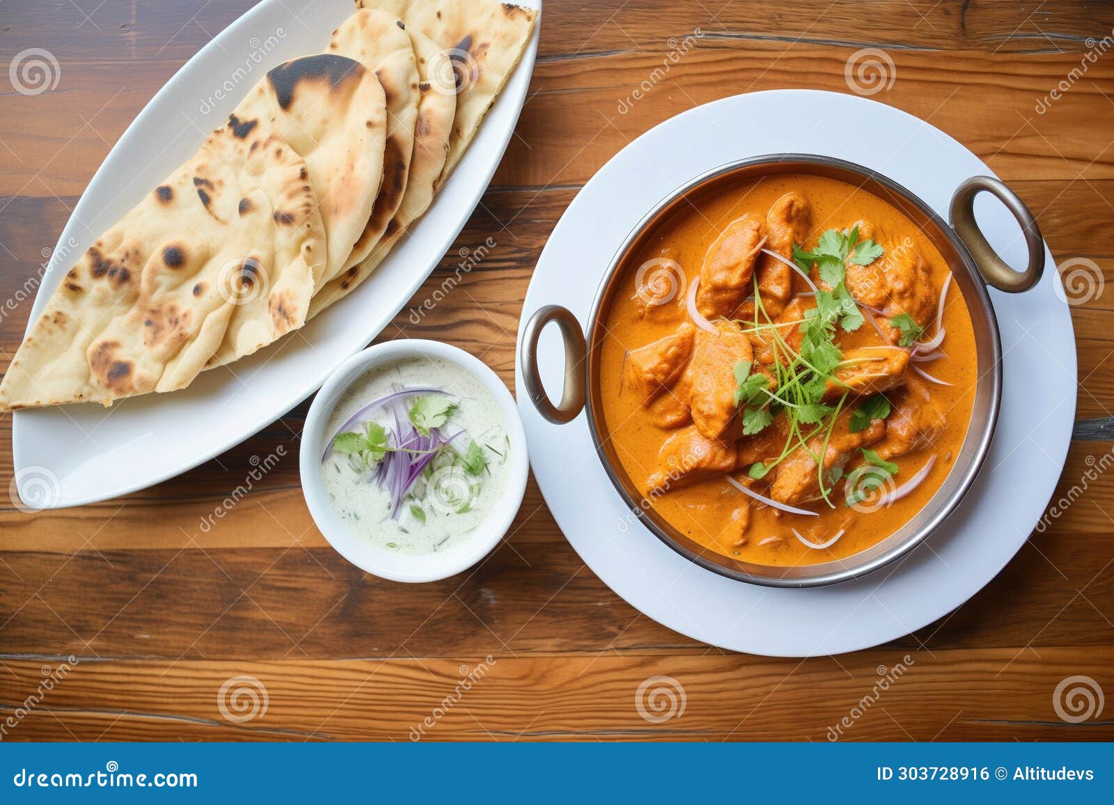 Top View of a Plate of Butter Chicken with Naan Bread on the Side Stock ...