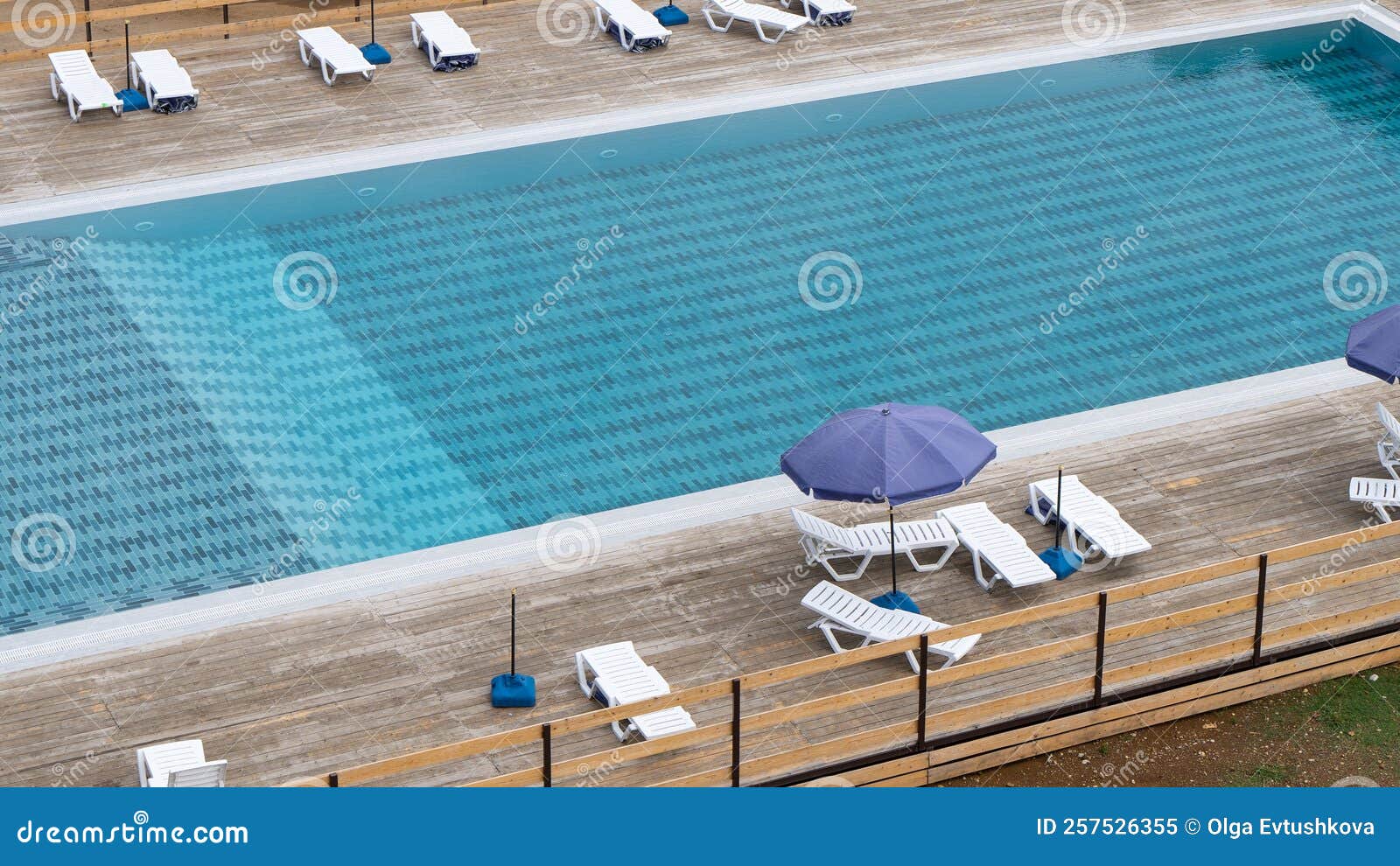 Top View of the Pool with Blue Water and Sun Loungers and Umbrellas ...