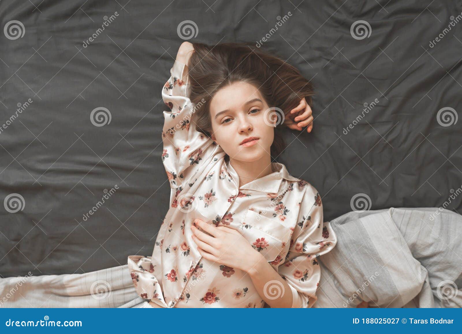 Top View A Portrait Of A Beautiful Girl Dressed In Pajamas Is Lying