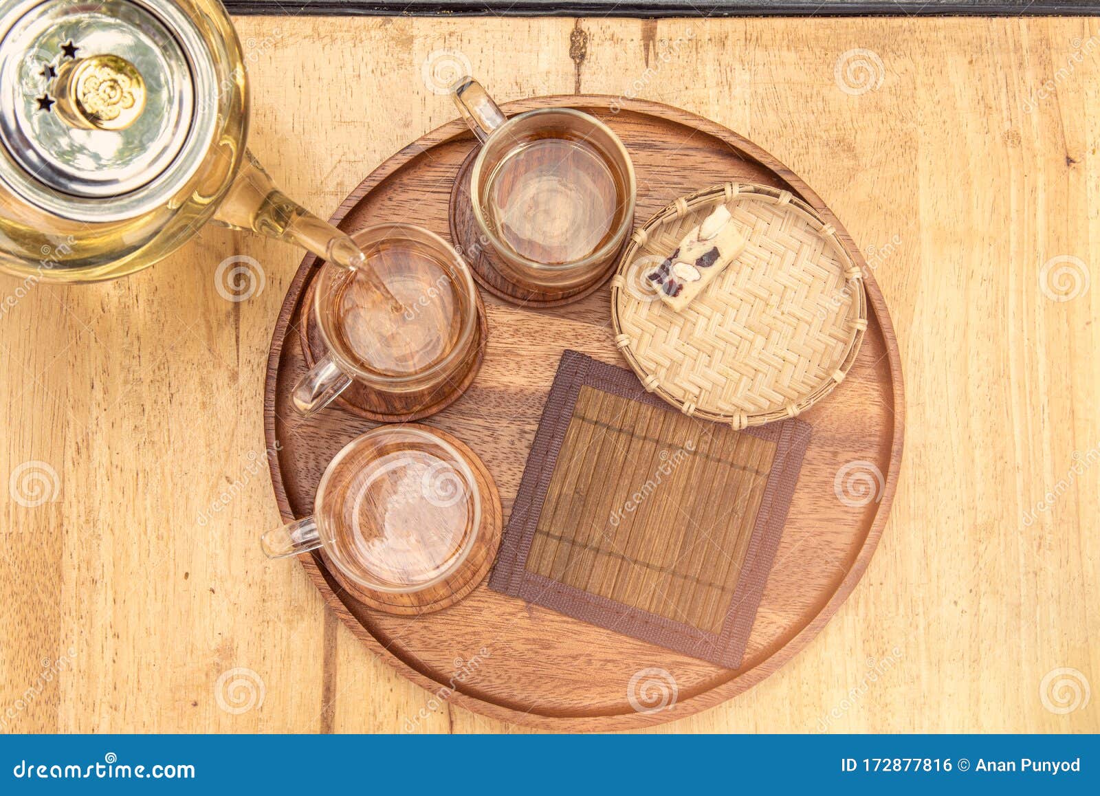 Top View Pour the Tea from the Kettle into a Cup of Tea on the Table ...