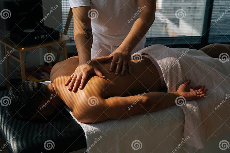 Top View Of Professional Male Masseur With Strong Tattooed Hands
