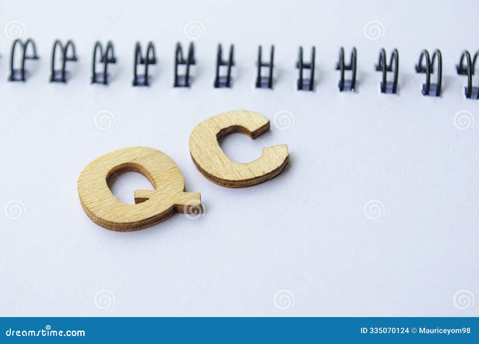 Top View of QC Wooden Letters on White Notepad. QC for Quality Control ...