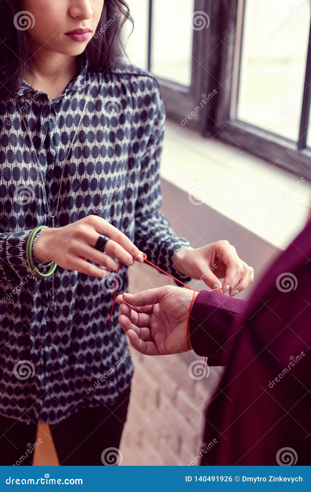 Top View of a Red Thread Being Put on the Hand Stock Photo - Image of ...