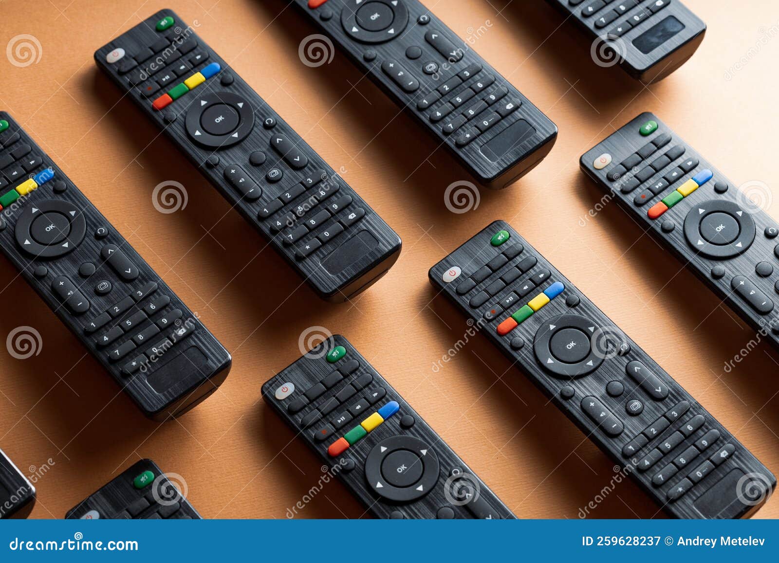 Top View of Remotes Laid Out in Two Rows on an Orange Surface Stock ...