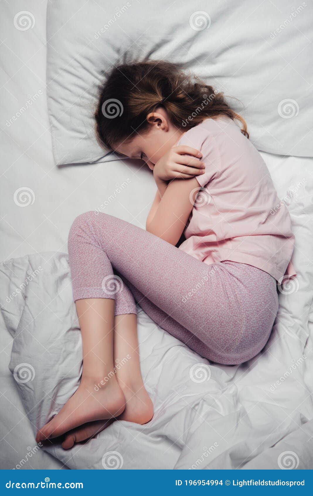 View of Scared Child Lying in Bed and Hugging Herself with Arms Stock ...