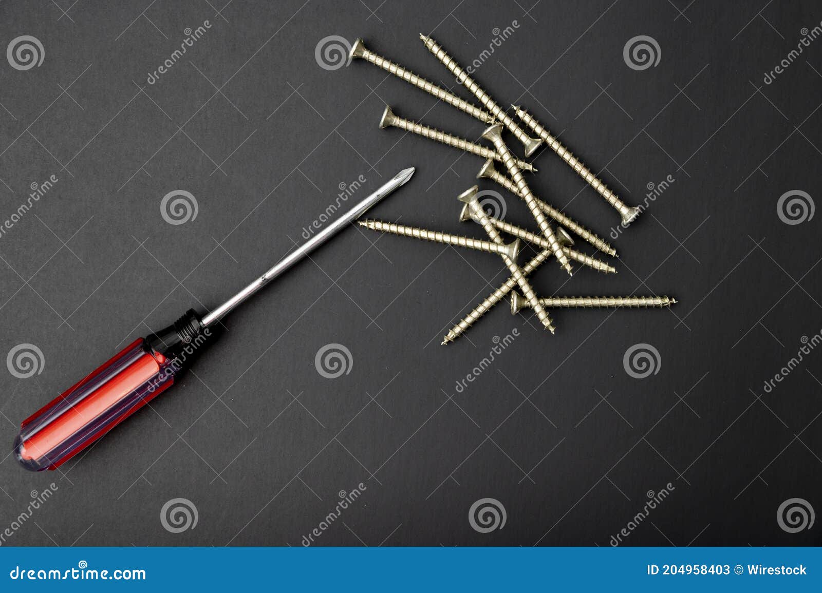 Top View of a Screwdriver with Self-tapping Screws on a Black ...