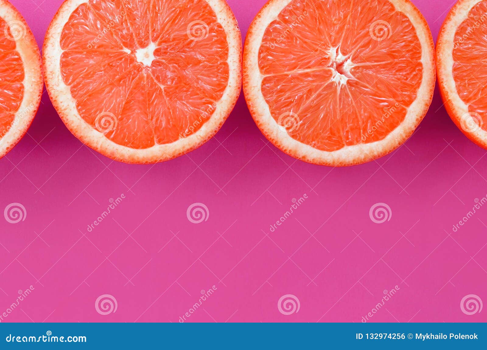 Top View of a Several Grapefruit Slices on Bright Background in Purple ...
