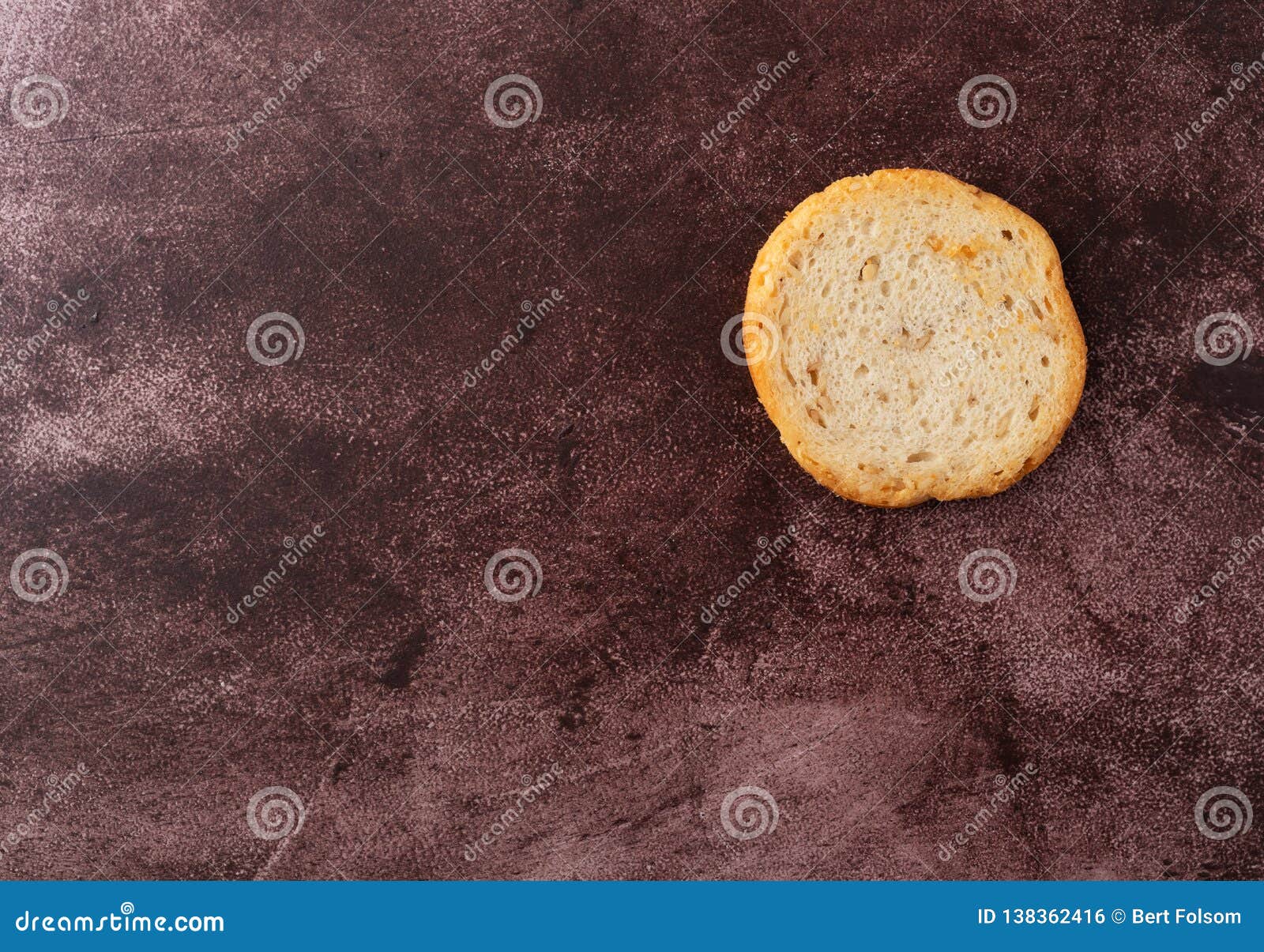 Top View of a Single Sesame Round Melba Toast Offset on a Maroon ...