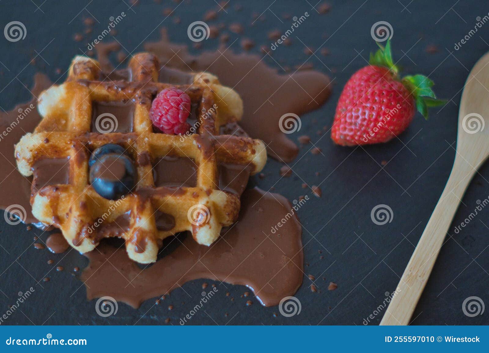Top View of a Single Waffle with Chocolate and Berries on the Blue ...