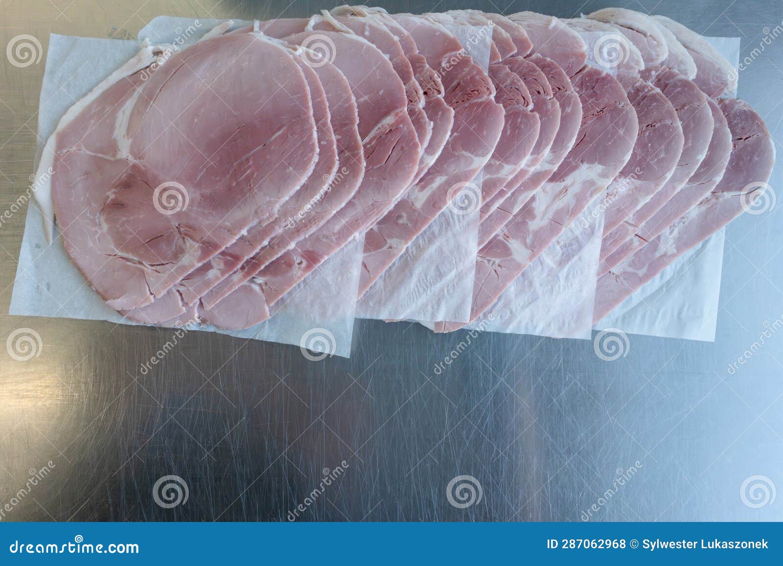 Top View Sliced Cooked Ham Separated with White Paper on a Metal Table ...