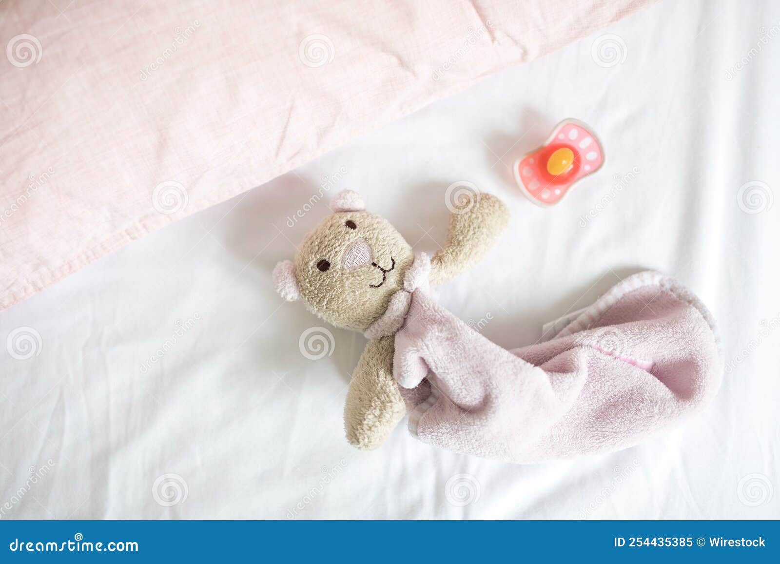 Top View of a Small Teddy Bear and Pacifier on Bed Stock Image - Image ...