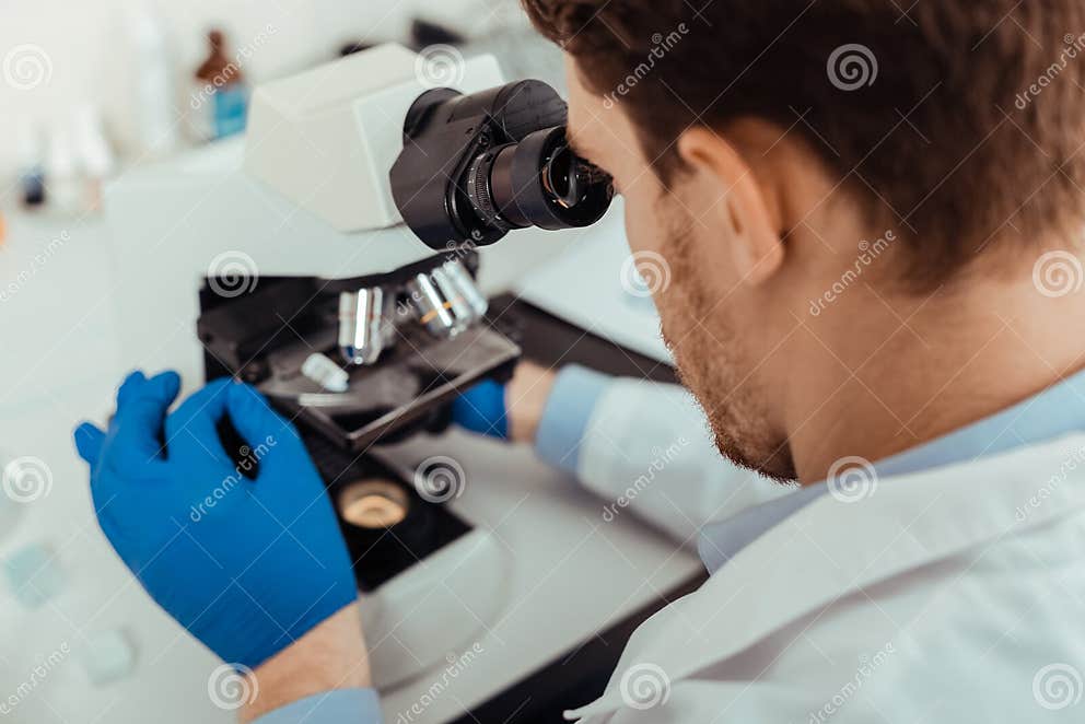 Top View of a Smart Man Looking into the Microscope Stock Image - Image ...