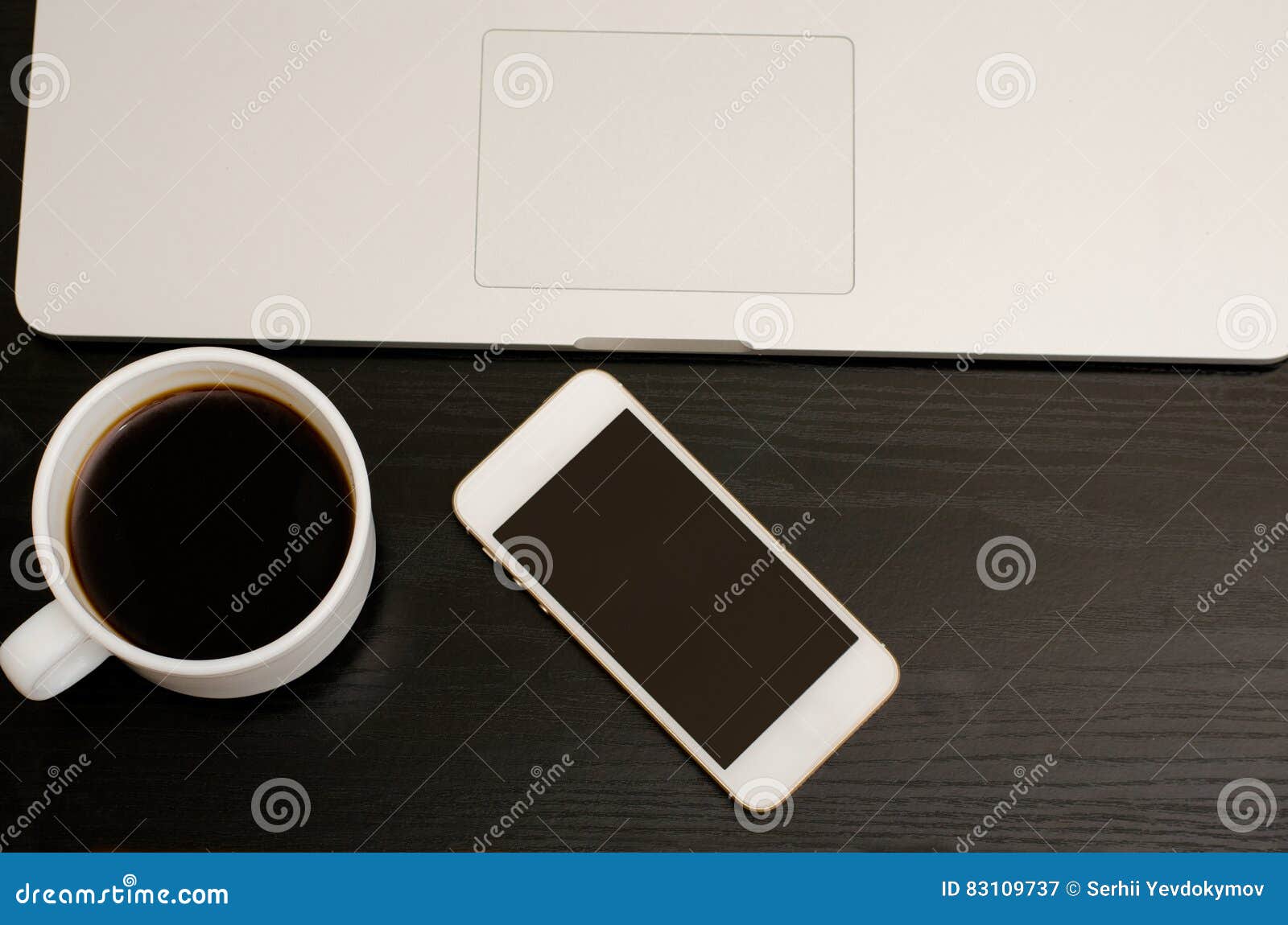 Top View of a Smart Phone and a Cup of Coffee Near Laptop on a Black ...