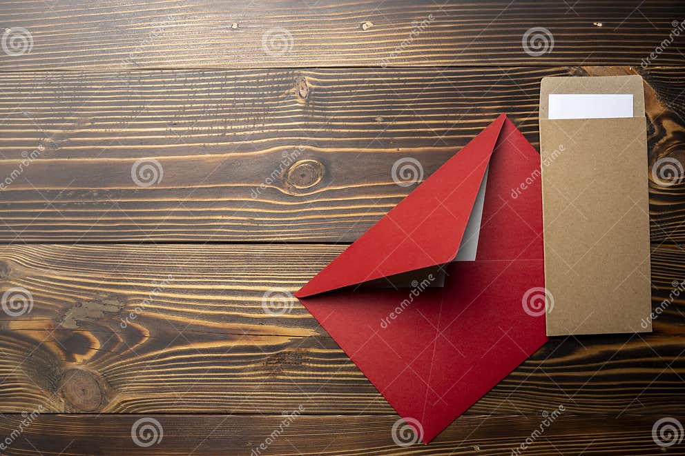 Top View of Stack of Two Envelope and Postcard on Wooden Background ...