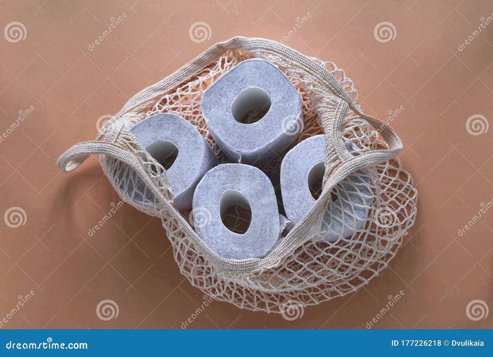 String Bag Full of Toilet Paper Rolls, Layout on a Beige Background ...