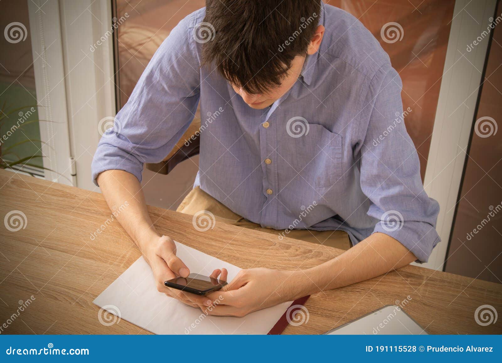 Student with Mobile Phone at Desk Stock Photo - Image of desk ...