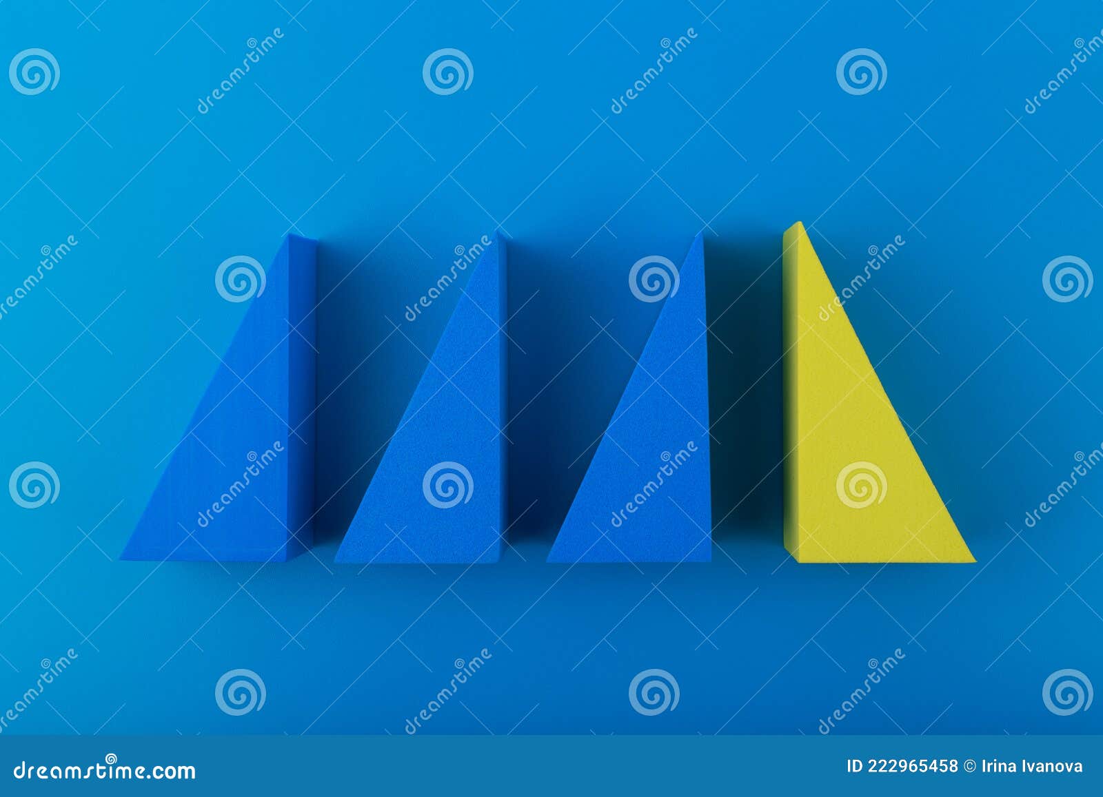 Top View of Three Blue and One Yellow Triangles Against Blue Background ...