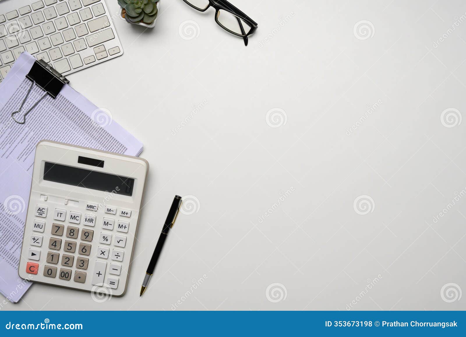 Top View of a Tidy Workspace with Calculator, Keyboard, Glasses and a ...