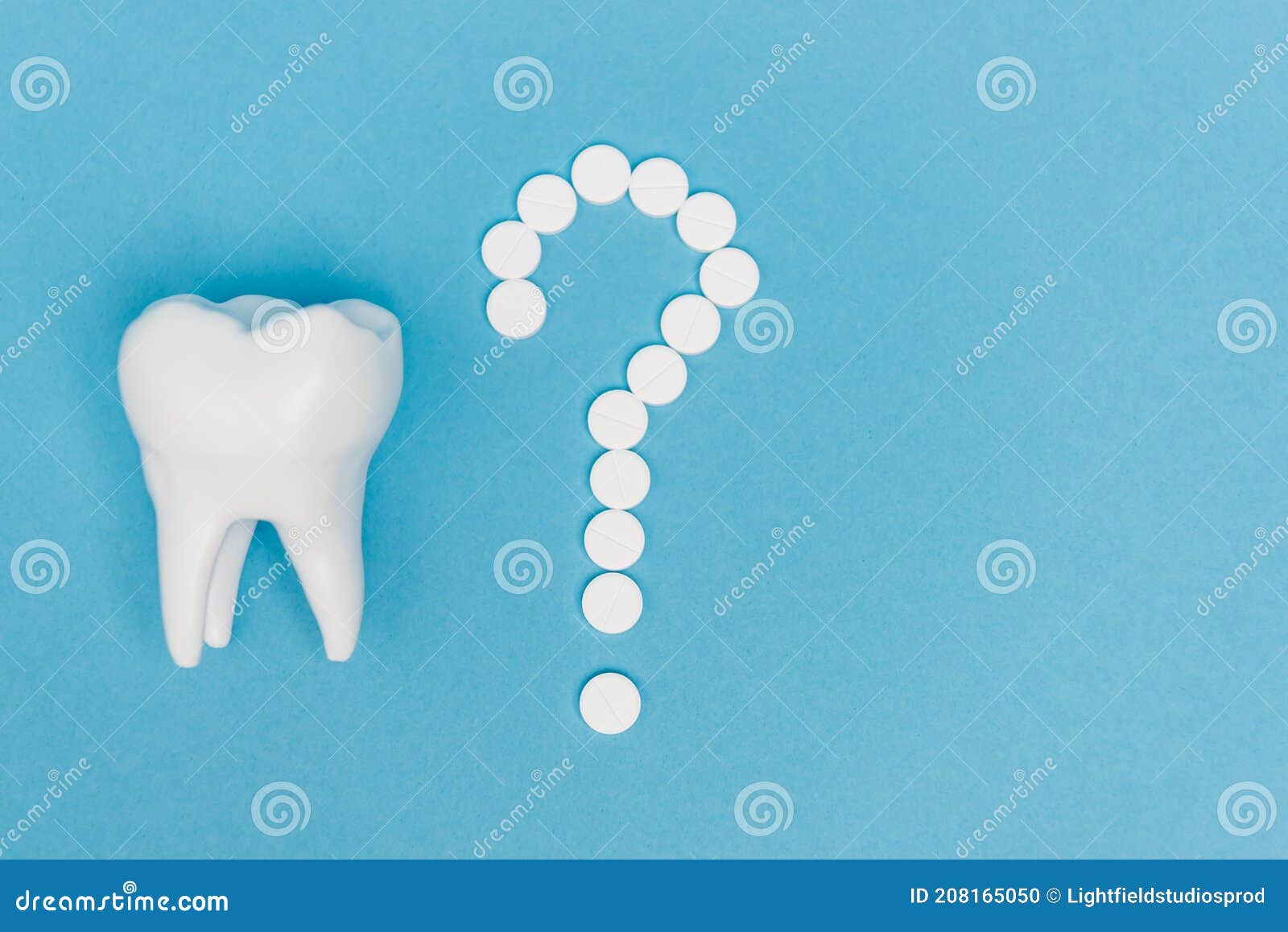 Top View of Tooth Model and Question Mark from Pills on Blue Background ...