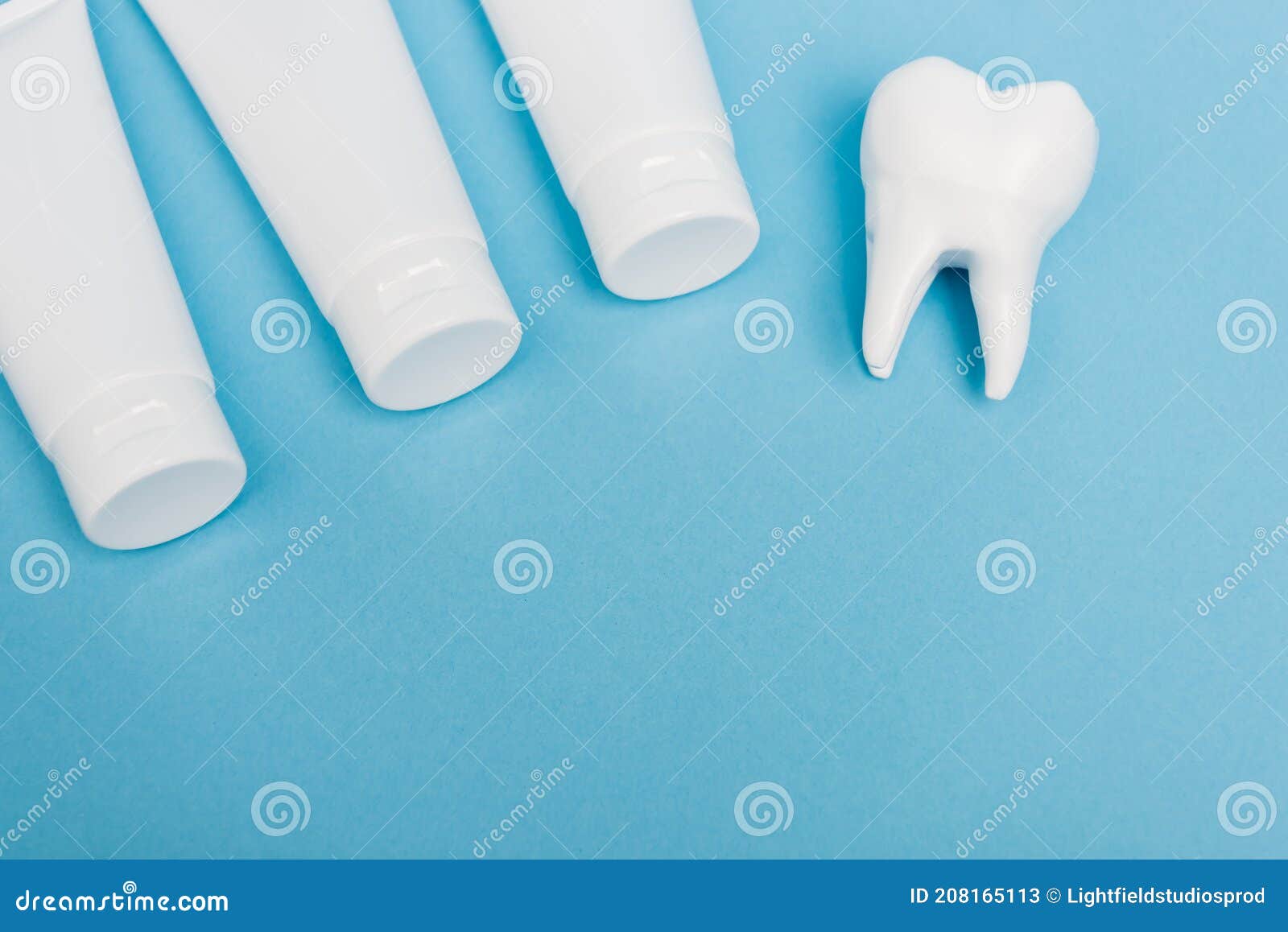 Top View of Tooth Model and Tubes with Toothpaste on Blue Background ...