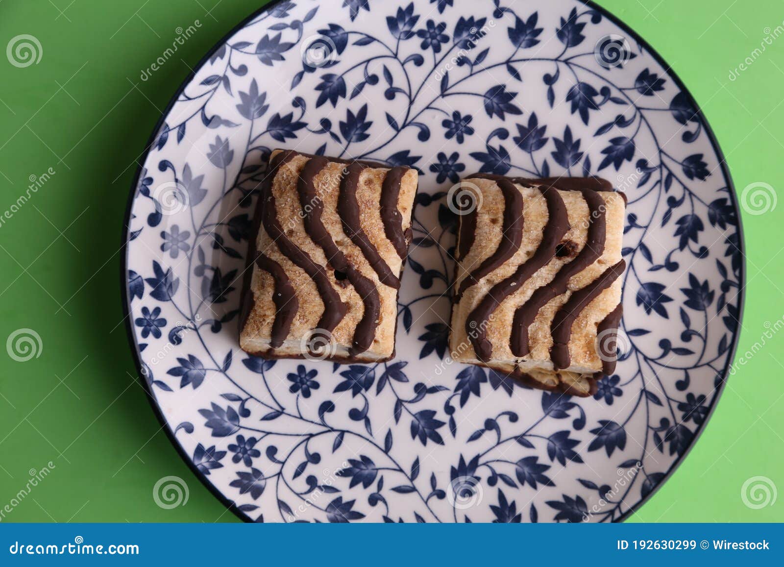 Top View of Two Chocolate Biscuits on a Plate Isolated on a Green ...