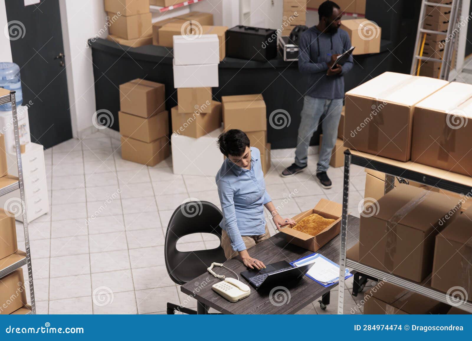 Top View of Warehouse Supervisor Packing Client Clothes Order in ...