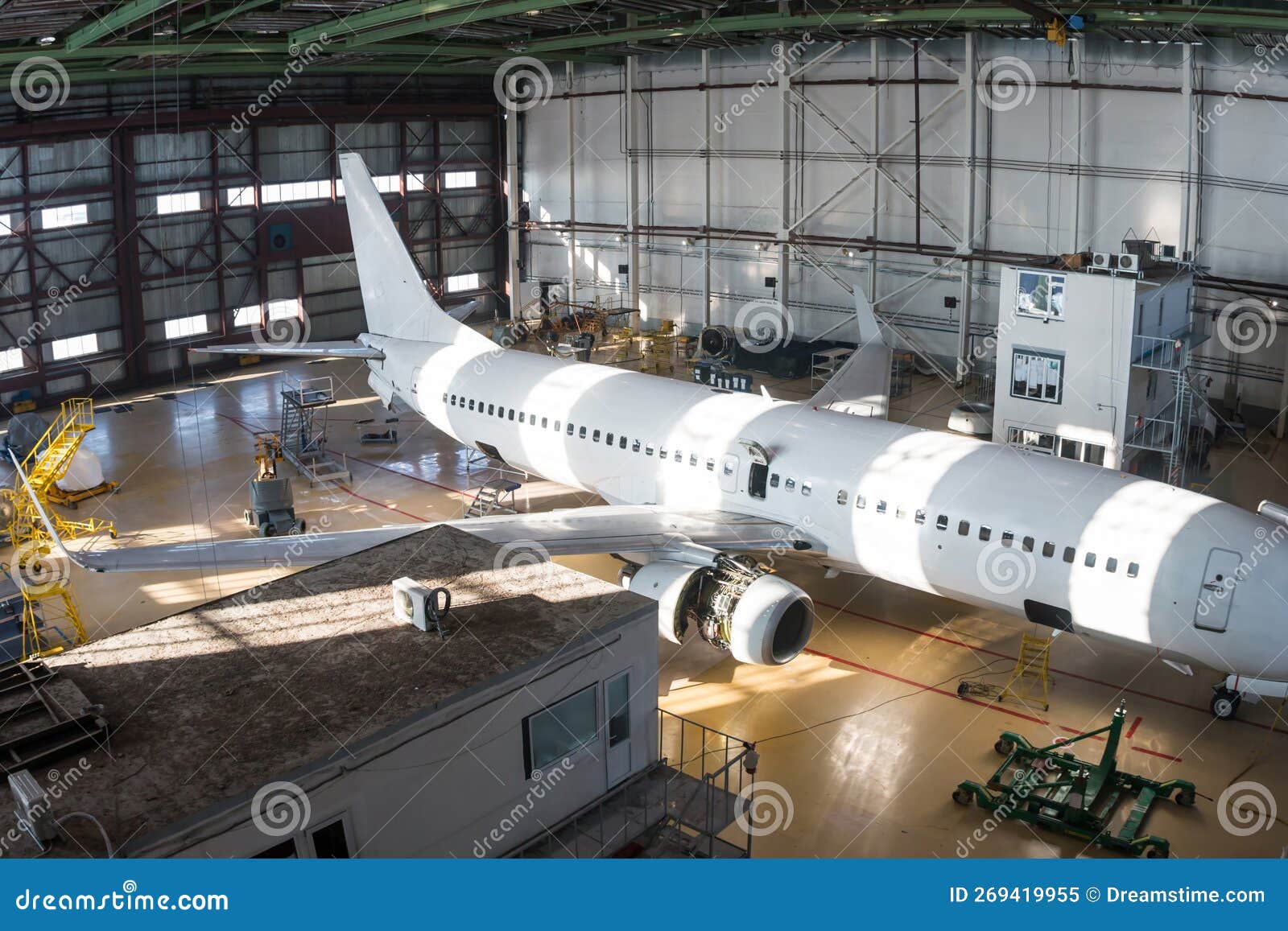 Top View of a White Passenger Aircraft in the Hangar. Airplane Under ...
