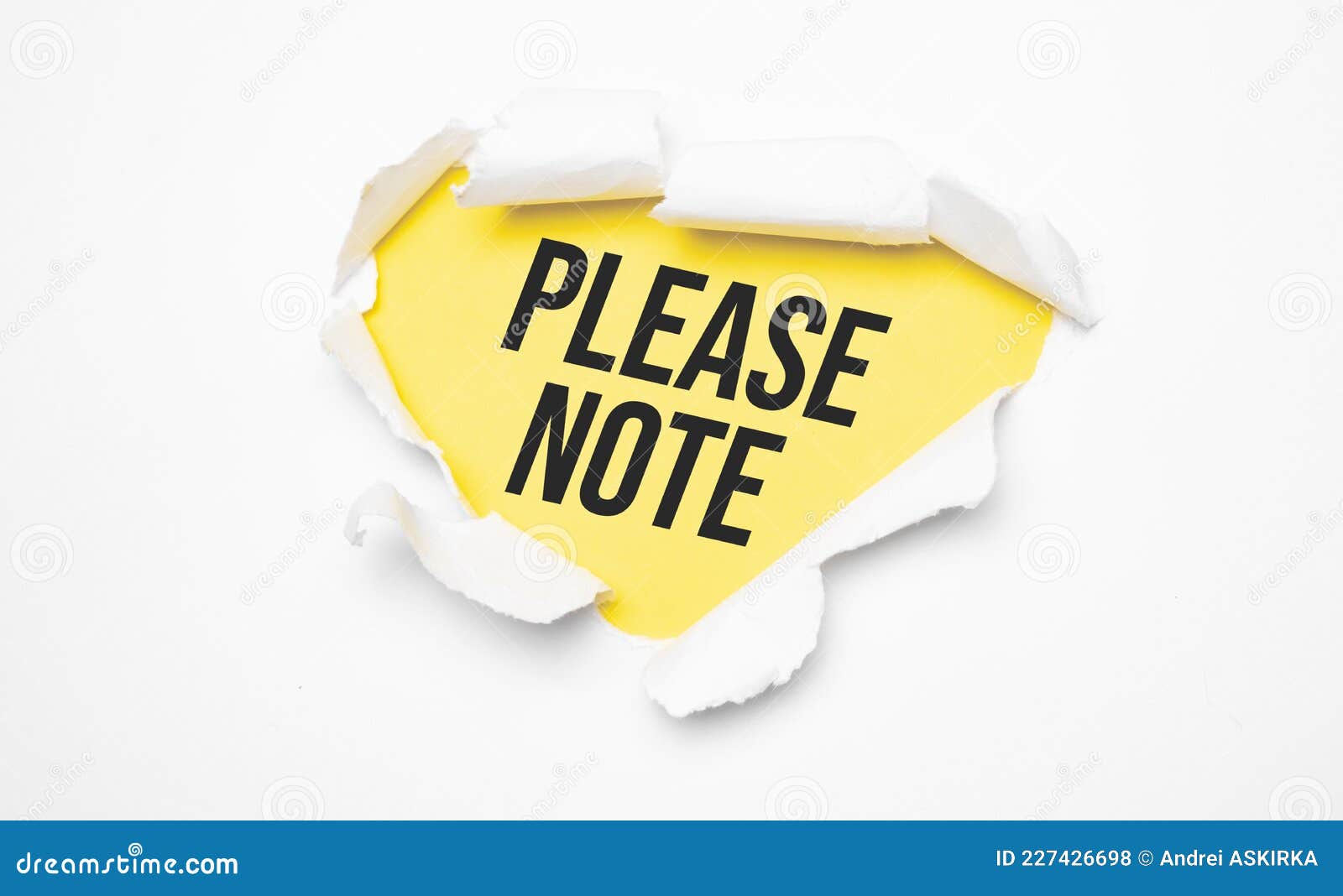 Top View of White Torn Paper and the Text PLEASE NOTE on a Yellow ...