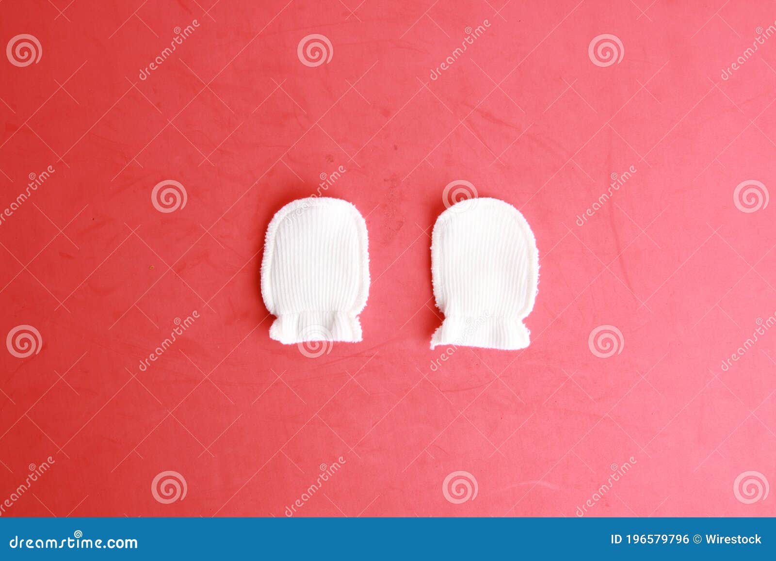Top View of White Wool Baby Mittens on a Red Background Stock Photo ...