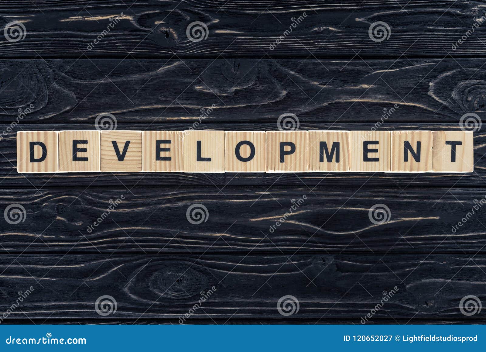 Top View of Word Development Made of Wooden Blocks on Dark Stock Image ...