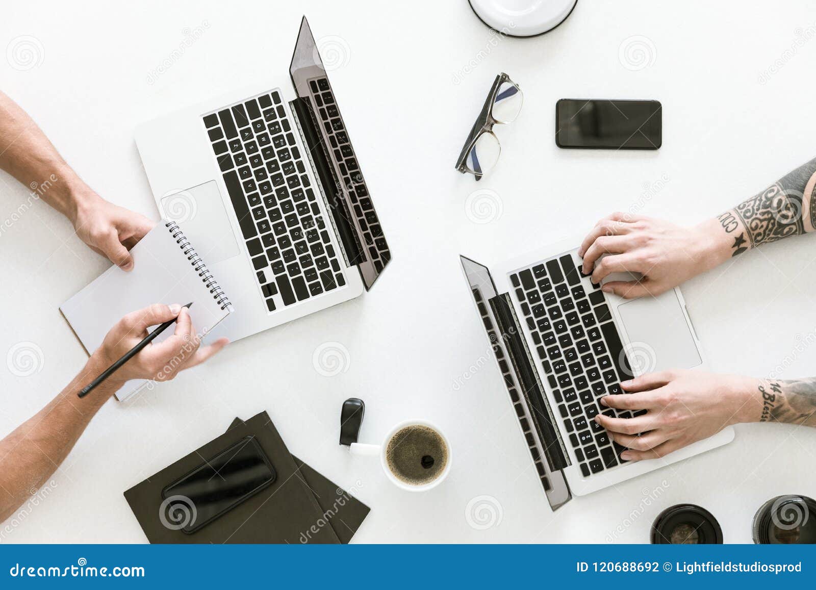 Top View of Workspace with Two Laptops and Male Hands Typing and ...