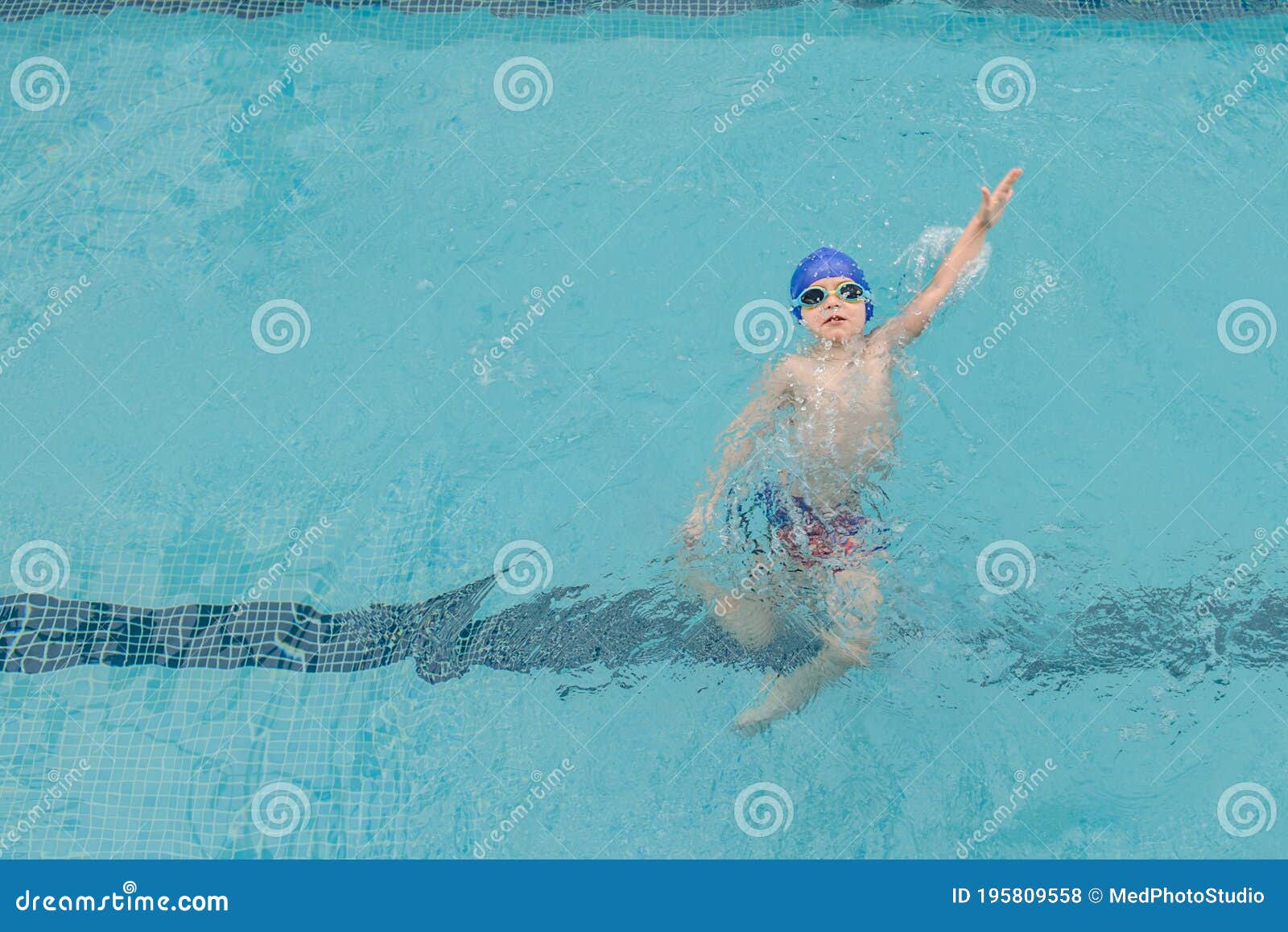 7-year Boy Swimming Backstroke in a Swimming Pool Stock Photo - Image ...