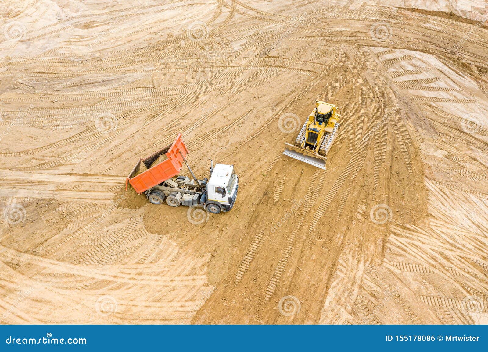 Top View of Yellow Bulldozer and Dump Truck Working at Construction ...