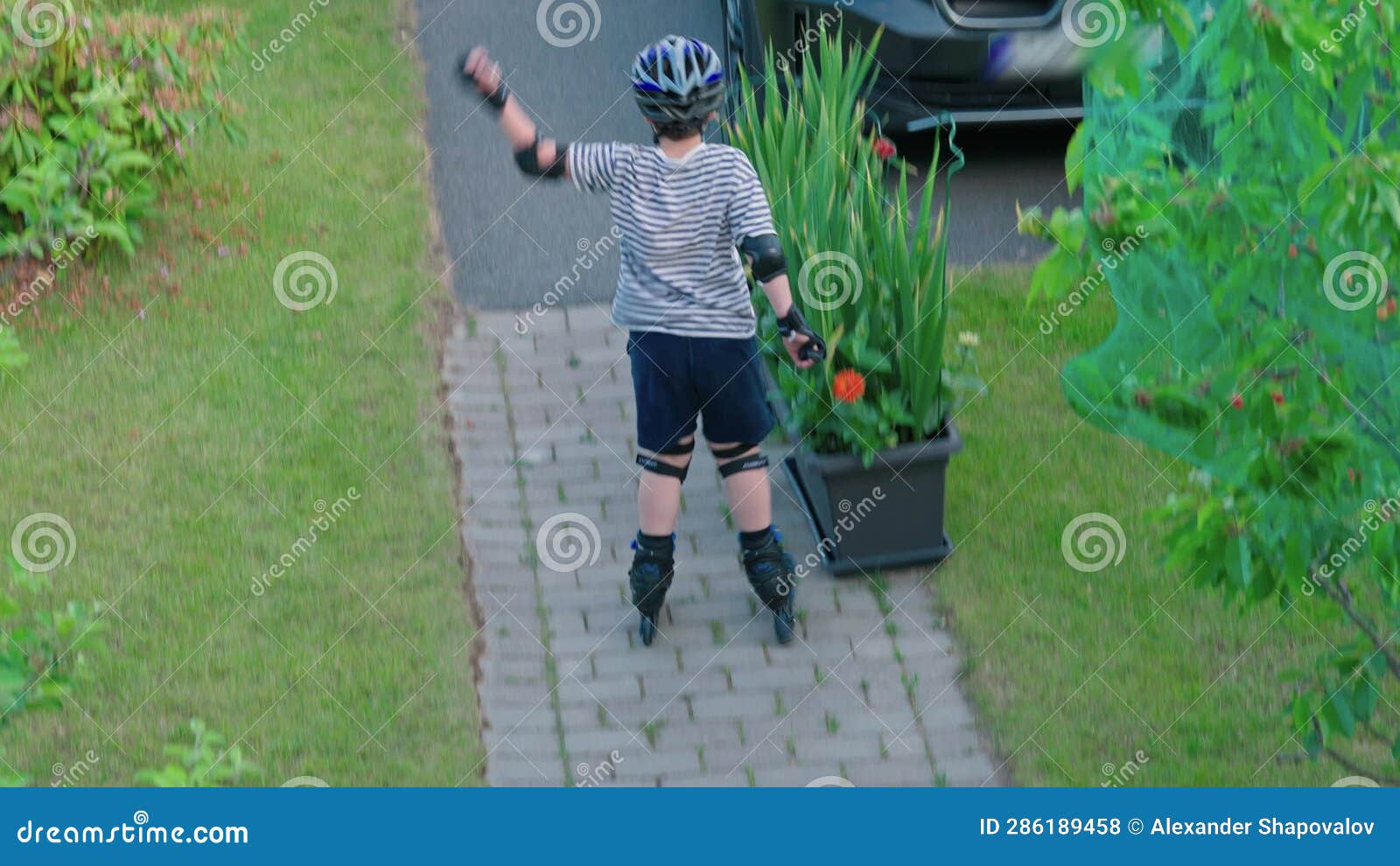Top View of Young Boy Learning Inline Skating in Garden on Sunny Summer ...