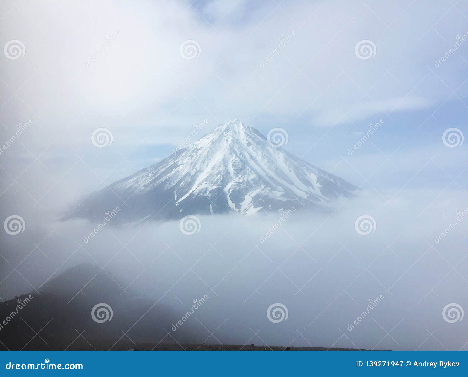 The Top of the Volcano is Visible through the Clouds Stock Image ...