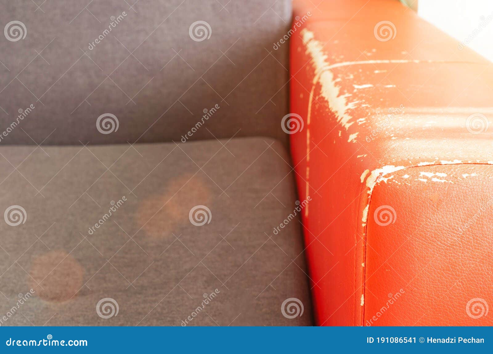 Torn and Battered Leather Back of the Sofa. Poor Quality Leather ...