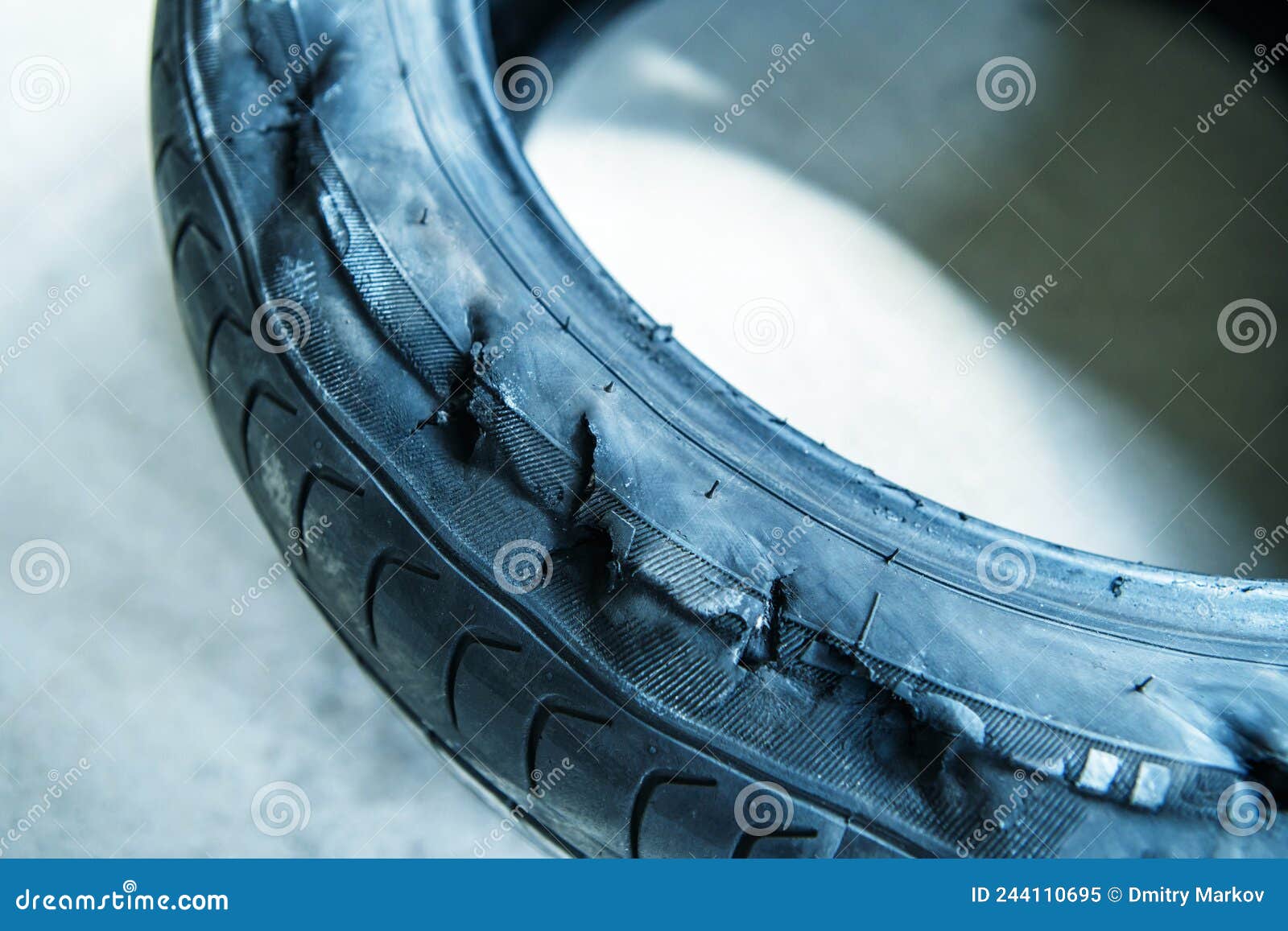 A Torn Car Tire after a Wheel Crashed into a Hole in the Road. Close-up ...