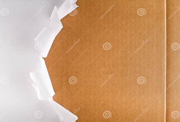 Torn Packaging Paper Revealing Cardboard Box Stock Photo - Image of ...