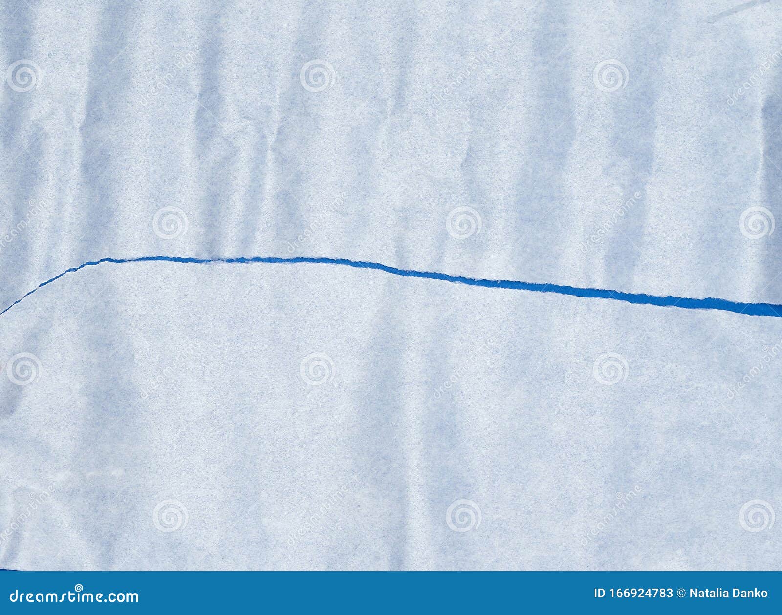 Torn Piece of White Parchment Paper on a Blue Background Stock Image ...