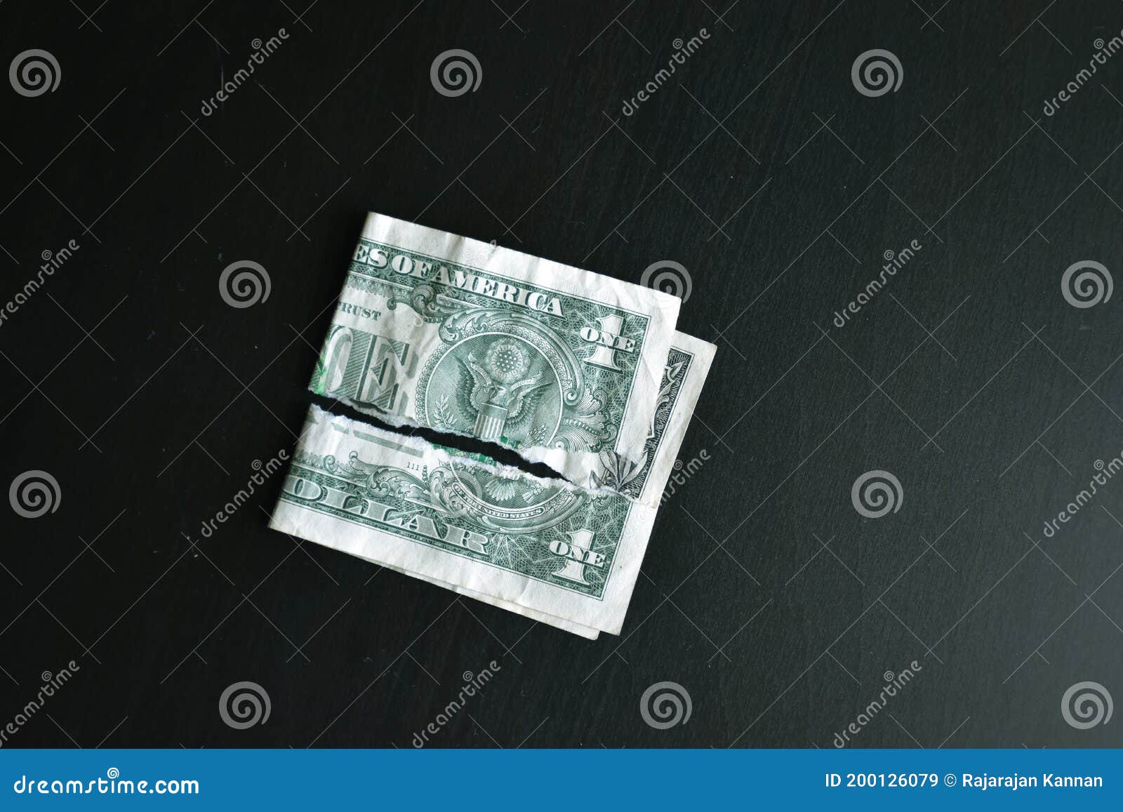 Torn Ripped Devalued One Dollar Bank Note On A Black Background. Close ...