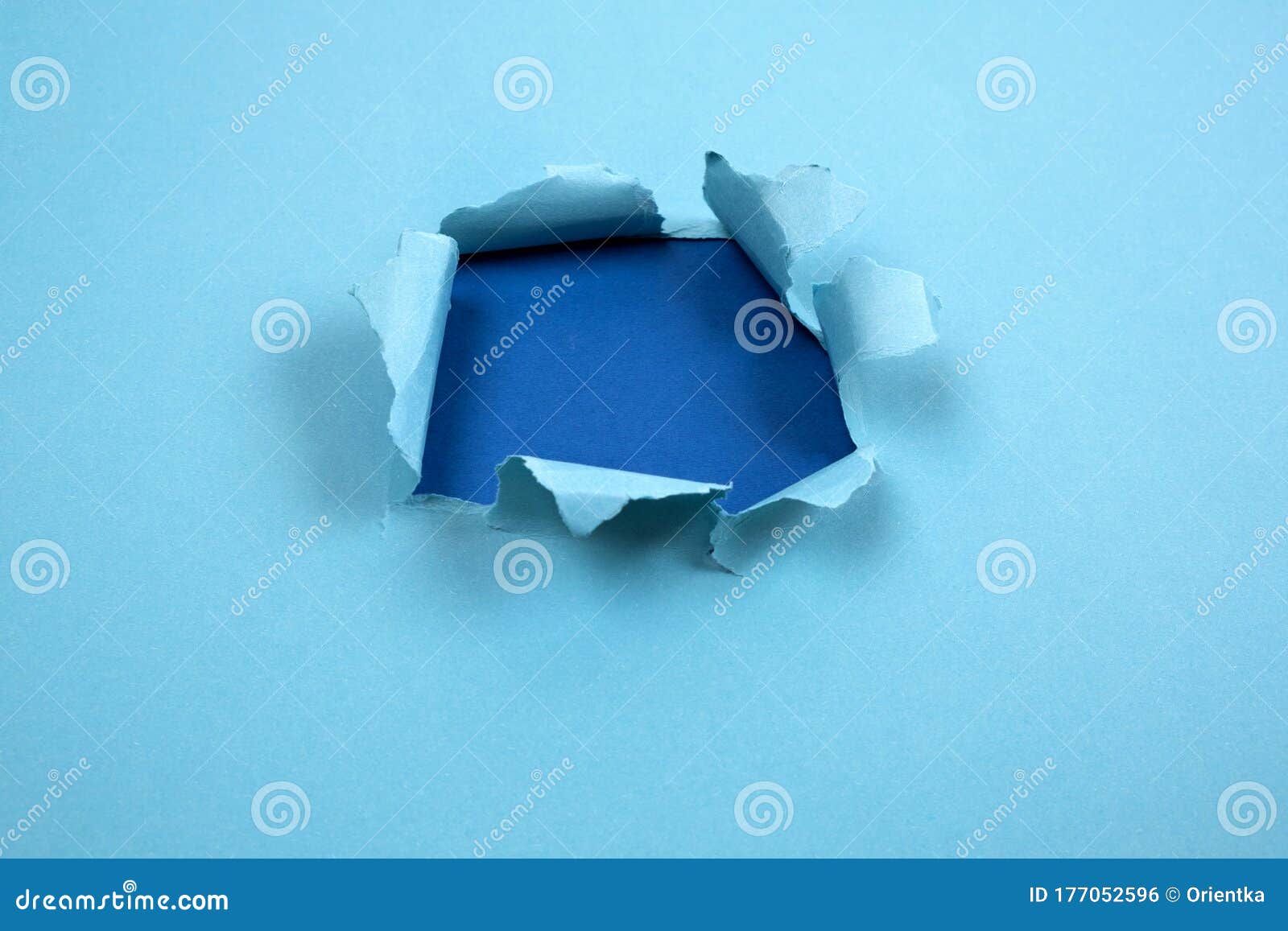 Torn Round Hole in Cyan Blue Paper with Torn Edges and a Blue ...