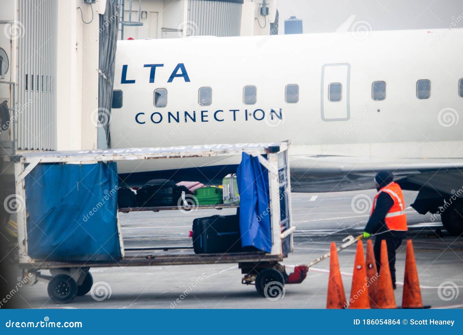 Toronto, Canada - March 11, 2019 : Airline Workers Loading Baggage Onto ...