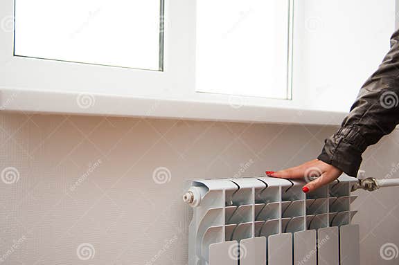 Touching the radiator stock photo. Image of heater, interior - 82541028