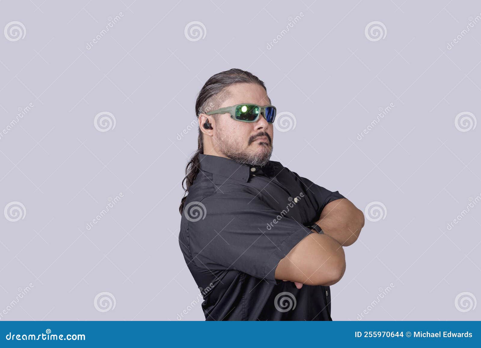 A Tough Looking Bodyguard or Security Escort with Arms Crossed ...