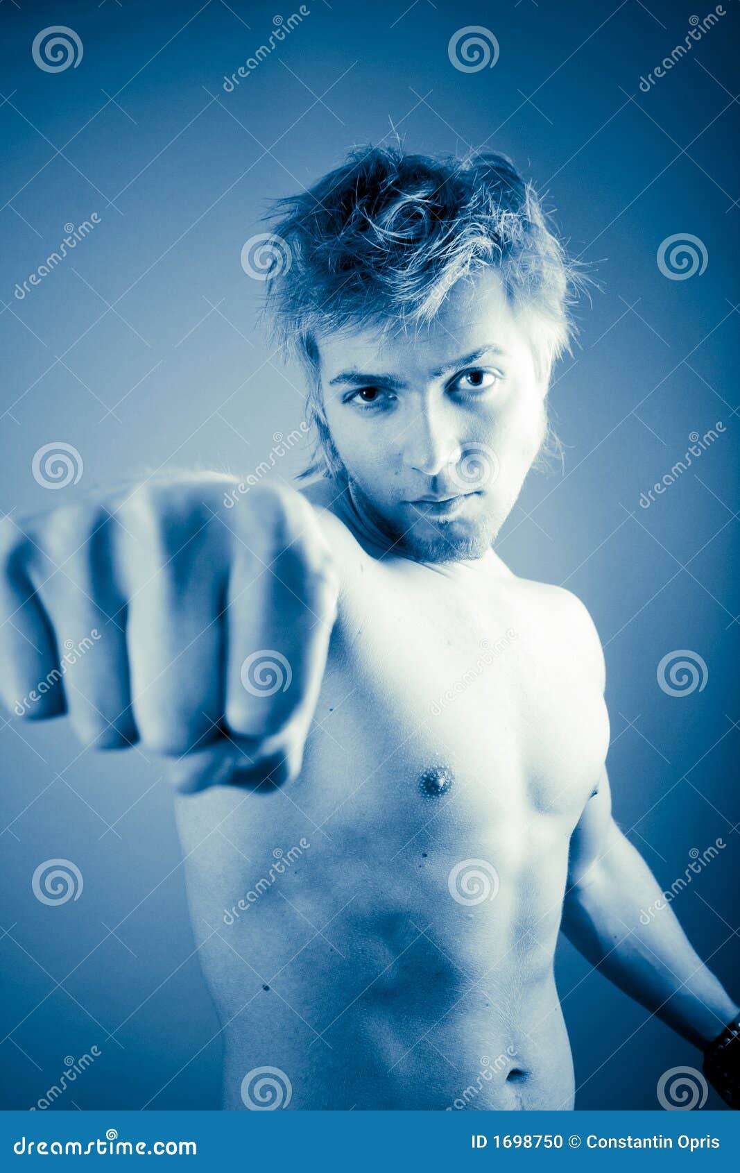 Tough male throwing punch stock photo. Image of hand, intent - 1698750
