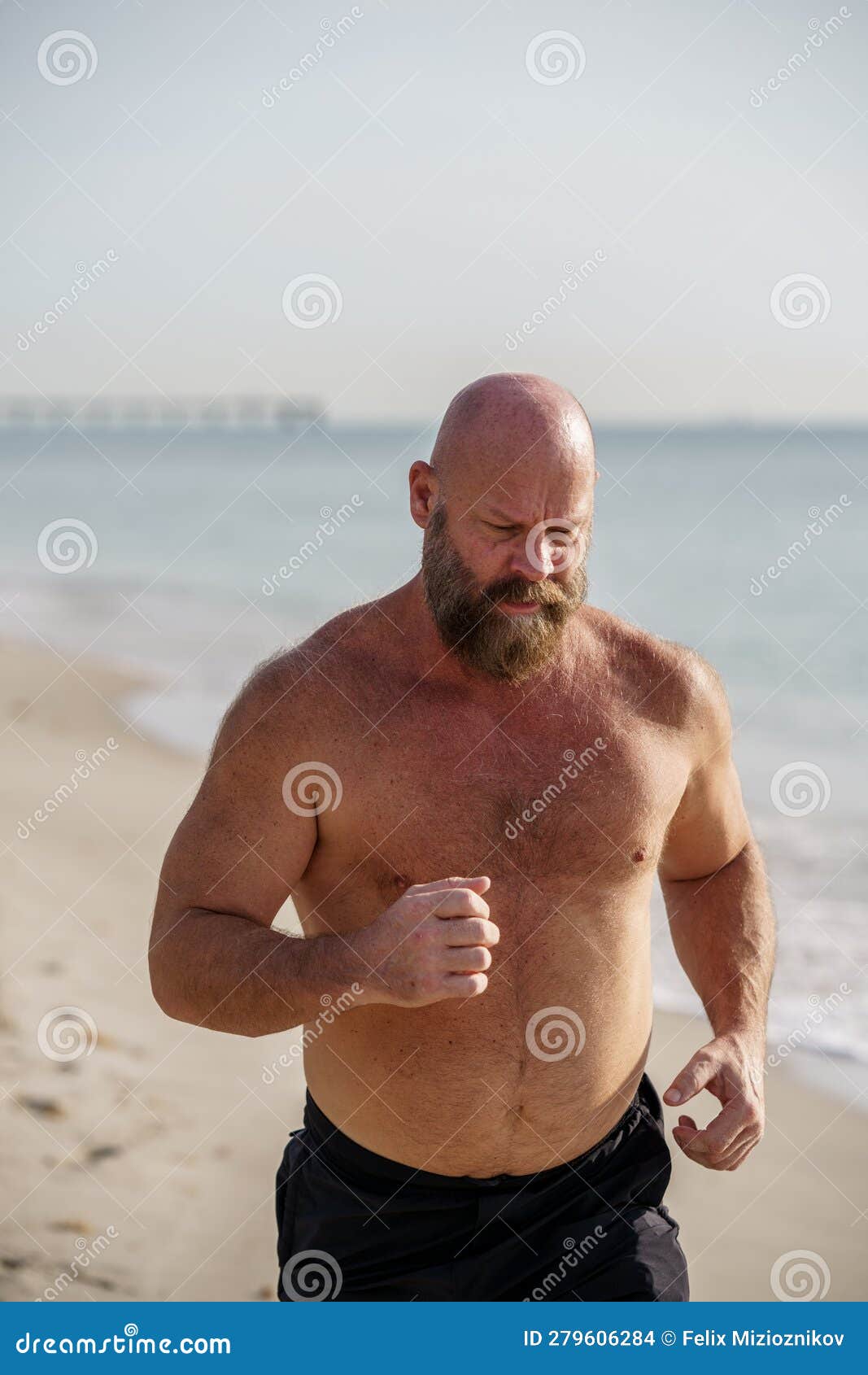 Tough White Guy Running on the Beach Stock Photo - Image of bald ...