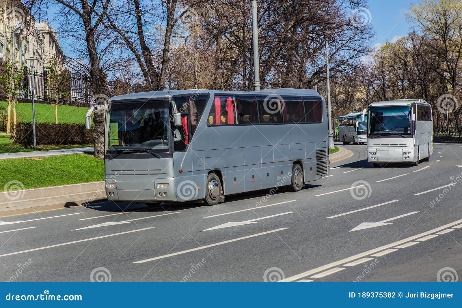Tour Buses Move on City Street Stock Photo - Image of city ...