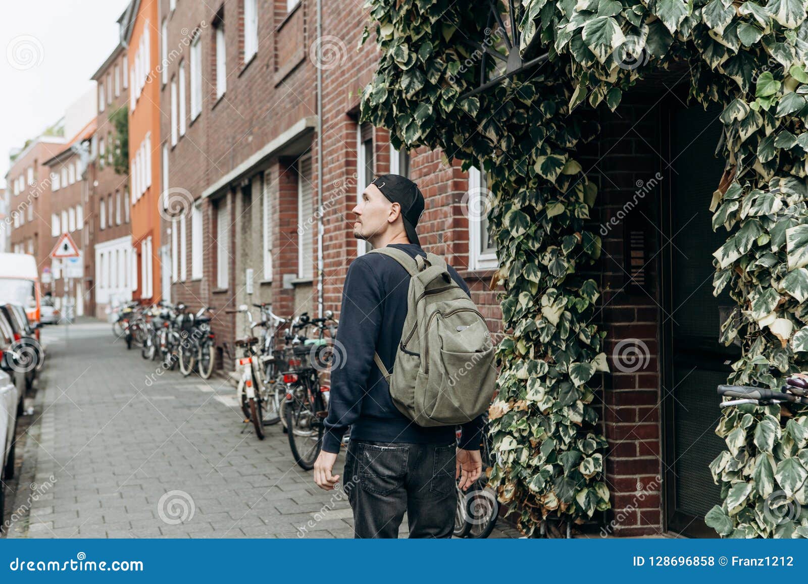 Tourist with a Backpack is Looking for Booked Online Accommodation in ...