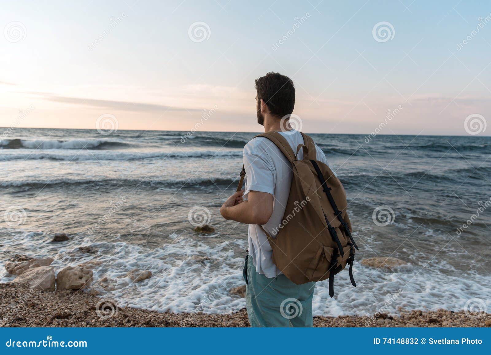 Tourist with Backpack Watching the Sunset Over the Sea Stock Photo ...
