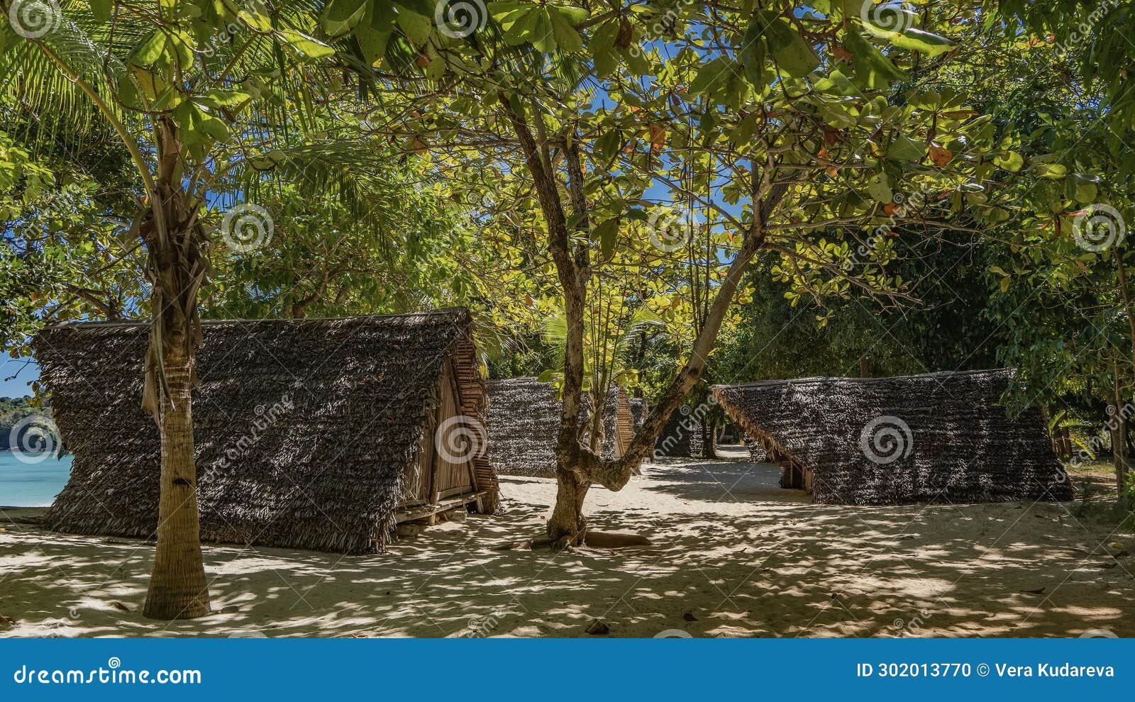 Tourist Bungalows with Triangular Thatched Roofs Stand in a Row on a ... Tourist Bungalows with Triangular Thatched Roofs Stand in a Row on a ...